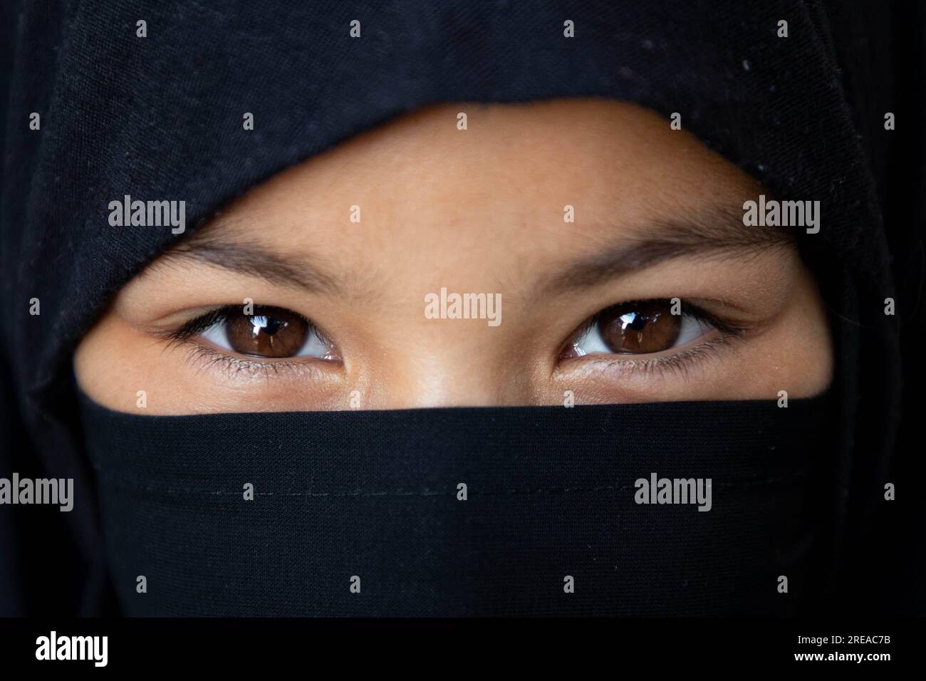 A Kashmiri Muslim Girl Looks Towards The Procession On The 7th Day Of Muharram In The Outskirts