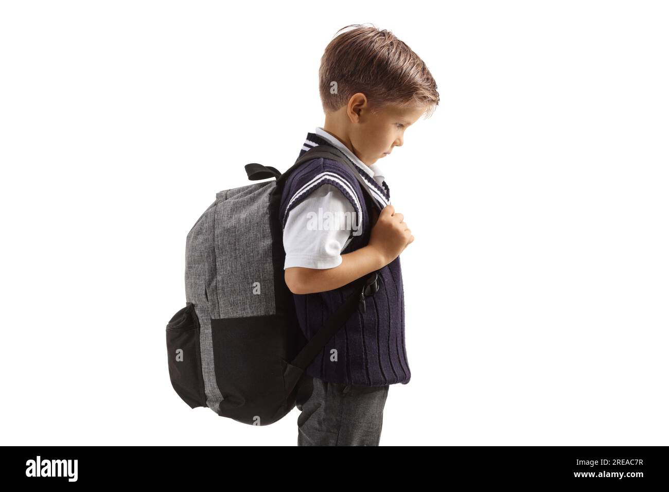 Sad boy with a backpack in a school uniform isolated on white ...