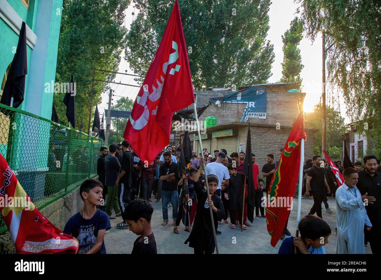 Srinagar, India. 25th July, 2023. Kashmiri Shiite Muslim children carrying religious flags as ...