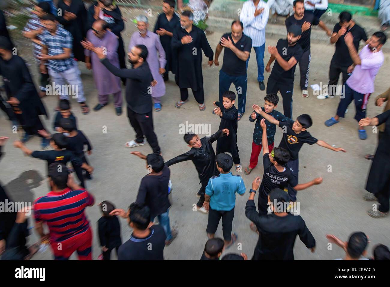 Srinagar, India. 25th July, 2023. Kashmiri Shiite Muslim children beat their chests during the ...