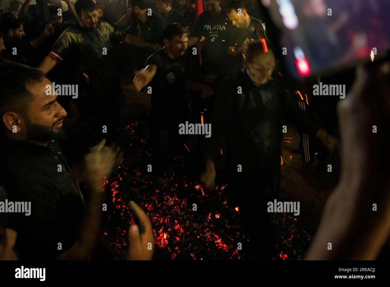 Srinagar, India. 25th July, 2023. Kashmiri Shiite Muslim men walk ...