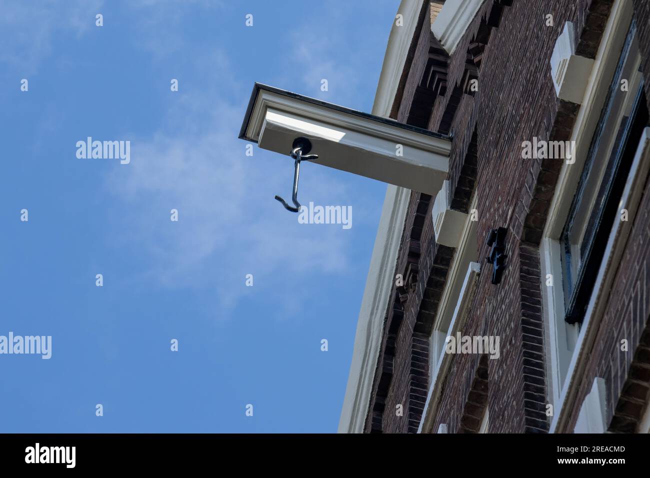 The characteristic hooks located in the top of Amsterdam houses serve ...