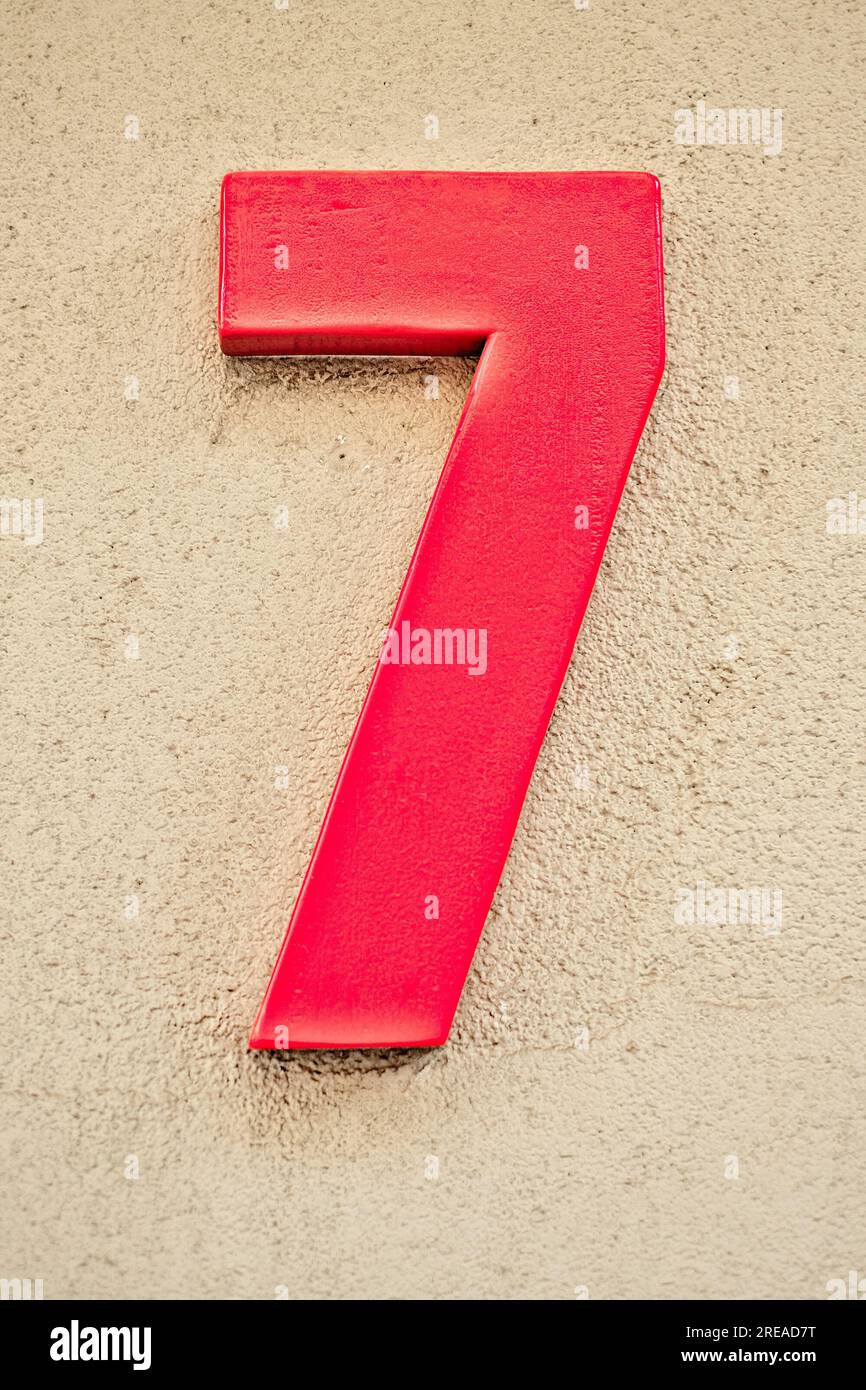 Number 7, seven, red digit on pale cream background Stock Photo - Alamy