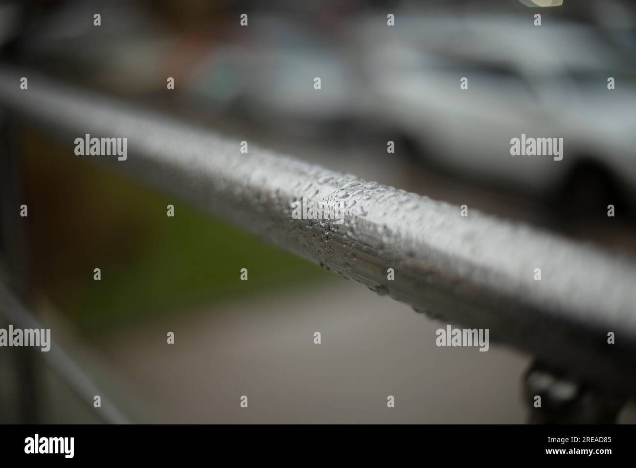 Wet handrail. Steel pipe in water droplets. Silver steel pole. Handrail ...