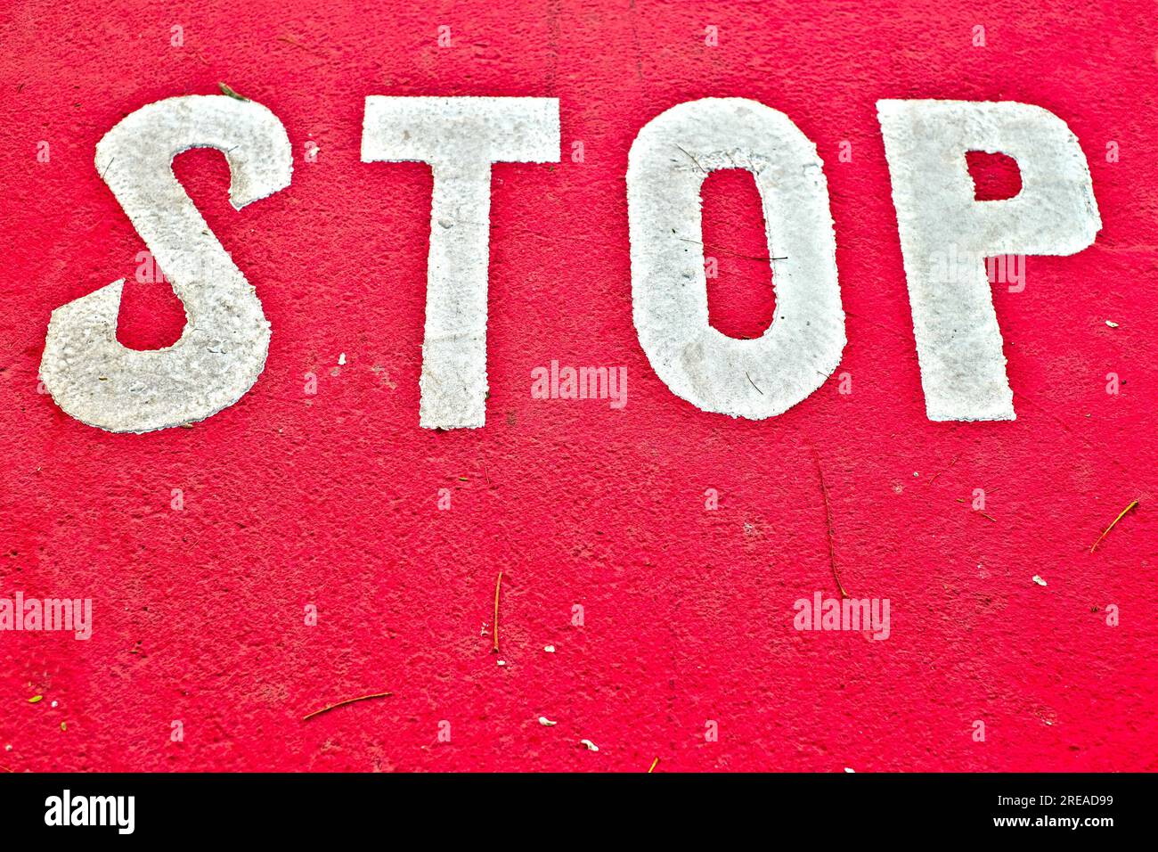 Word STOP in white letters on neon red background Stock Photo - Alamy