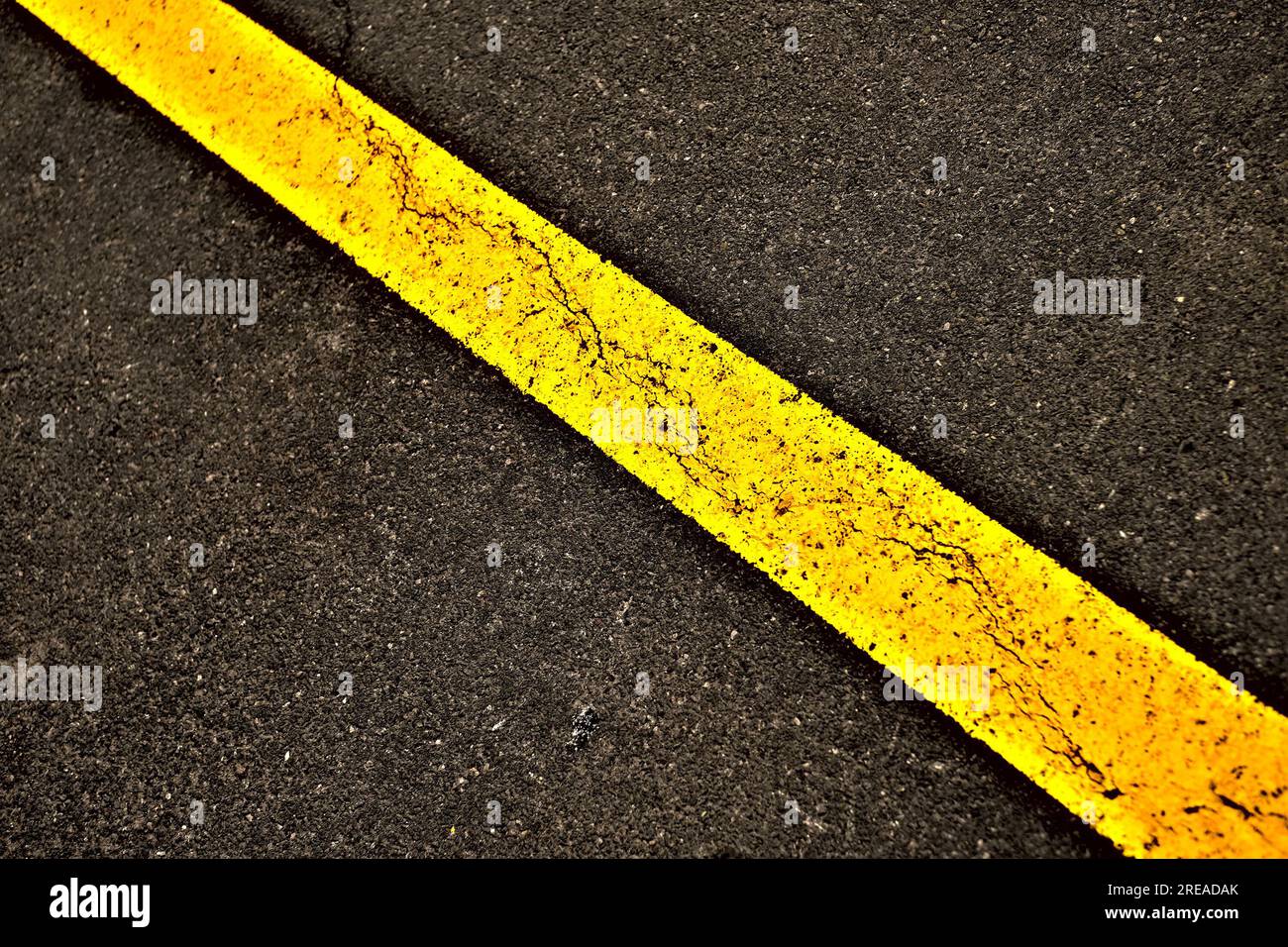 Broad neon yellow band in diagonal perspective on a black surface ...