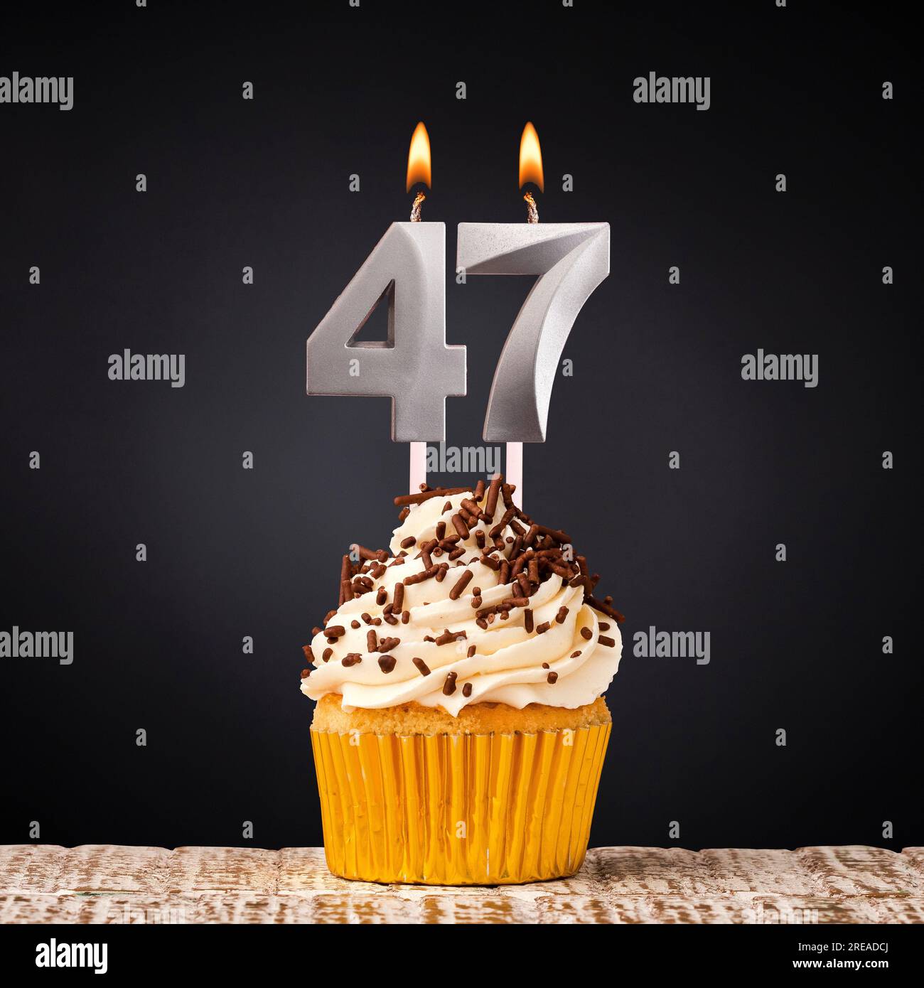 Birthday candle number 47 - Anniversary cupcake on black background ...