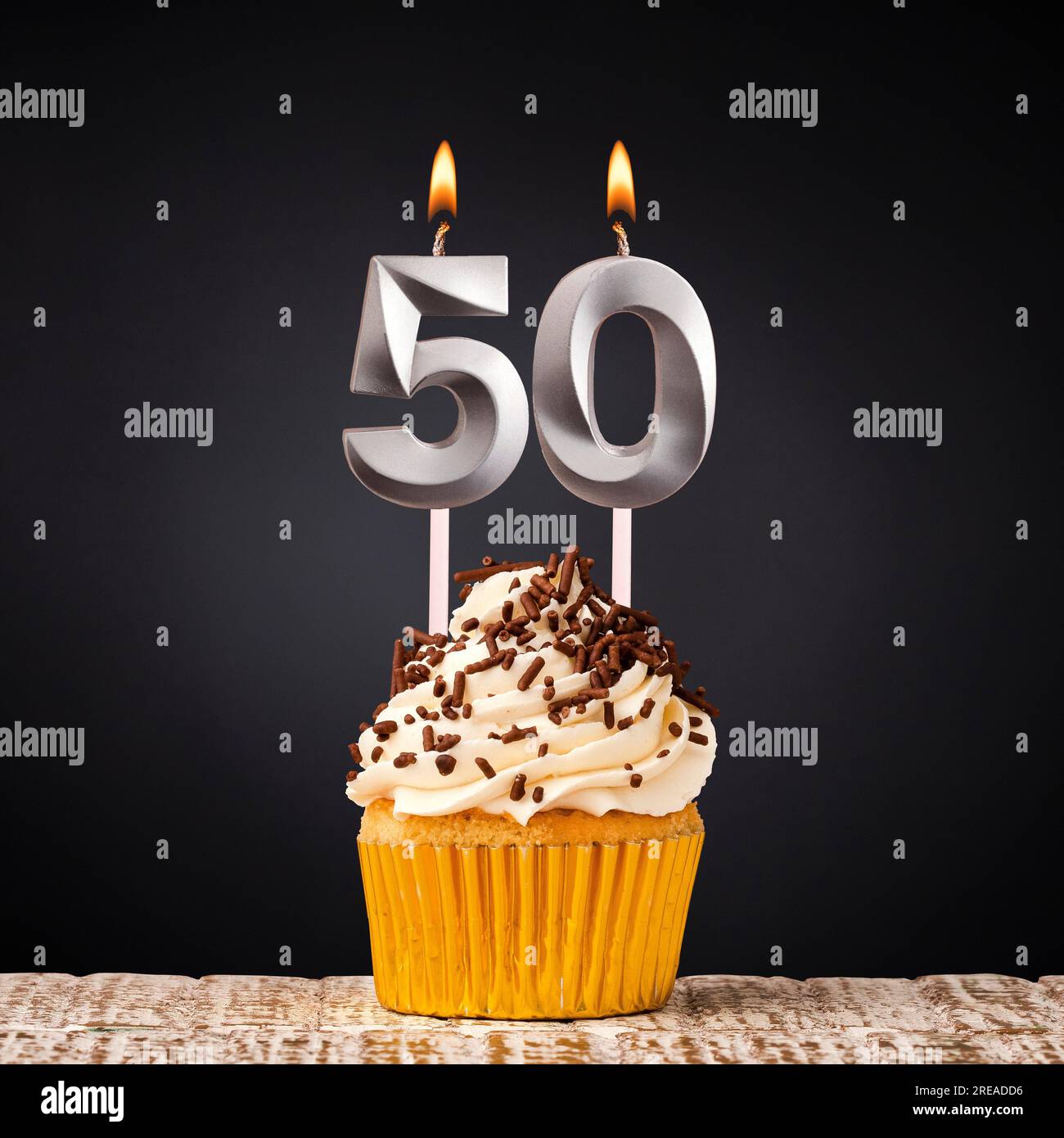 birthday cupcake with number 50 candle - Celebration on dark background ...