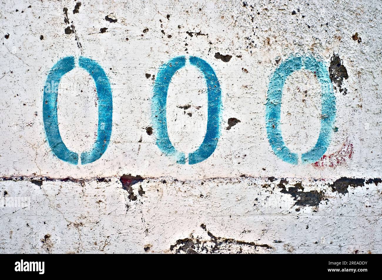 Three blue zero digits painted on a white wall Stock Photo - Alamy