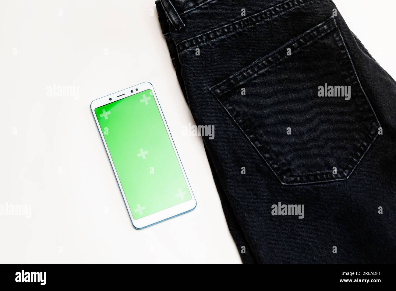 Flat Lay Shopping with smartphone, chroma key green screen, jeans cloth ...