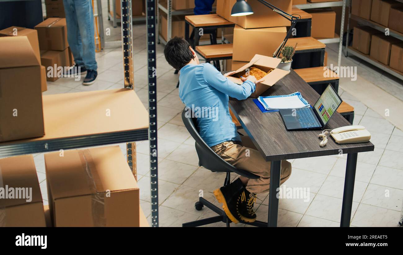 Young entrepreneur woman sorting boxes hi-res stock photography and ...