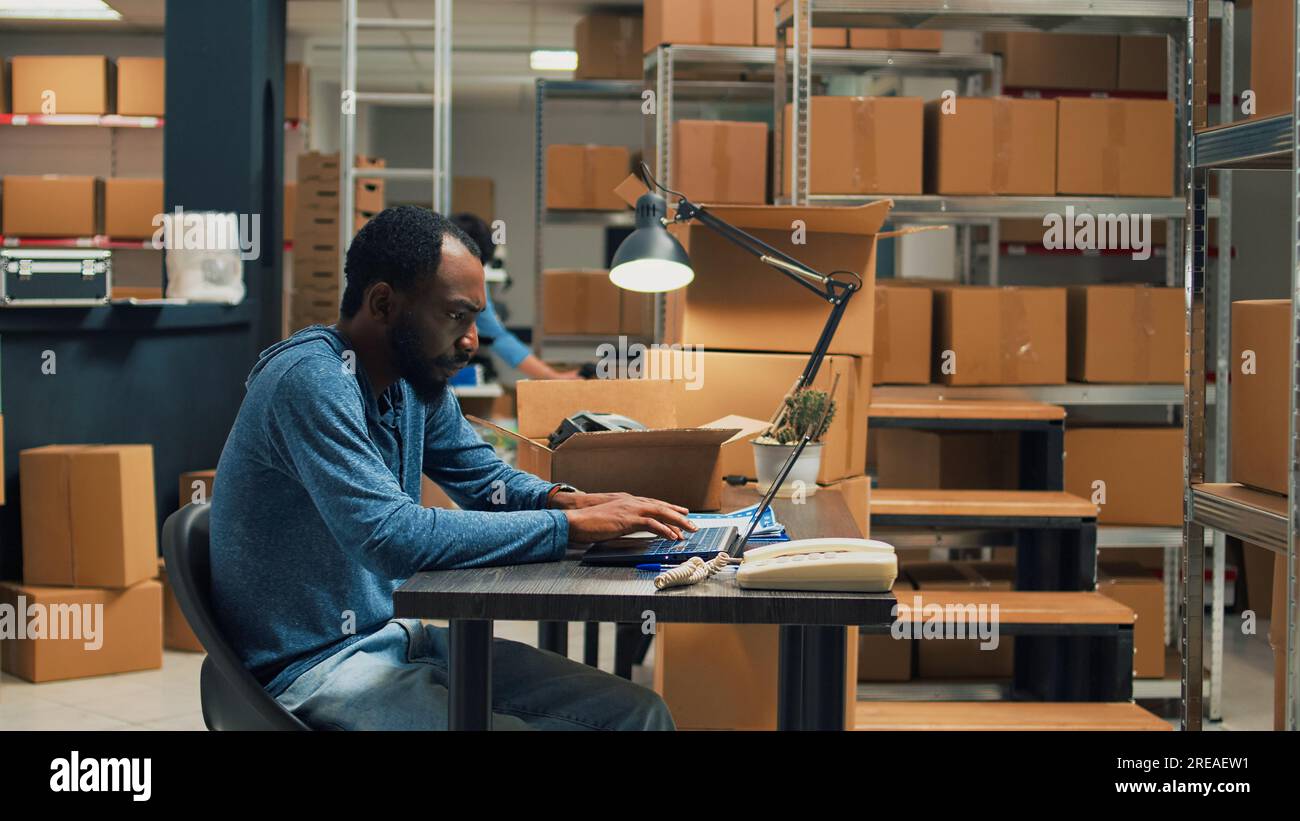 Young man checking shelves using hi-res stock photography and images ...