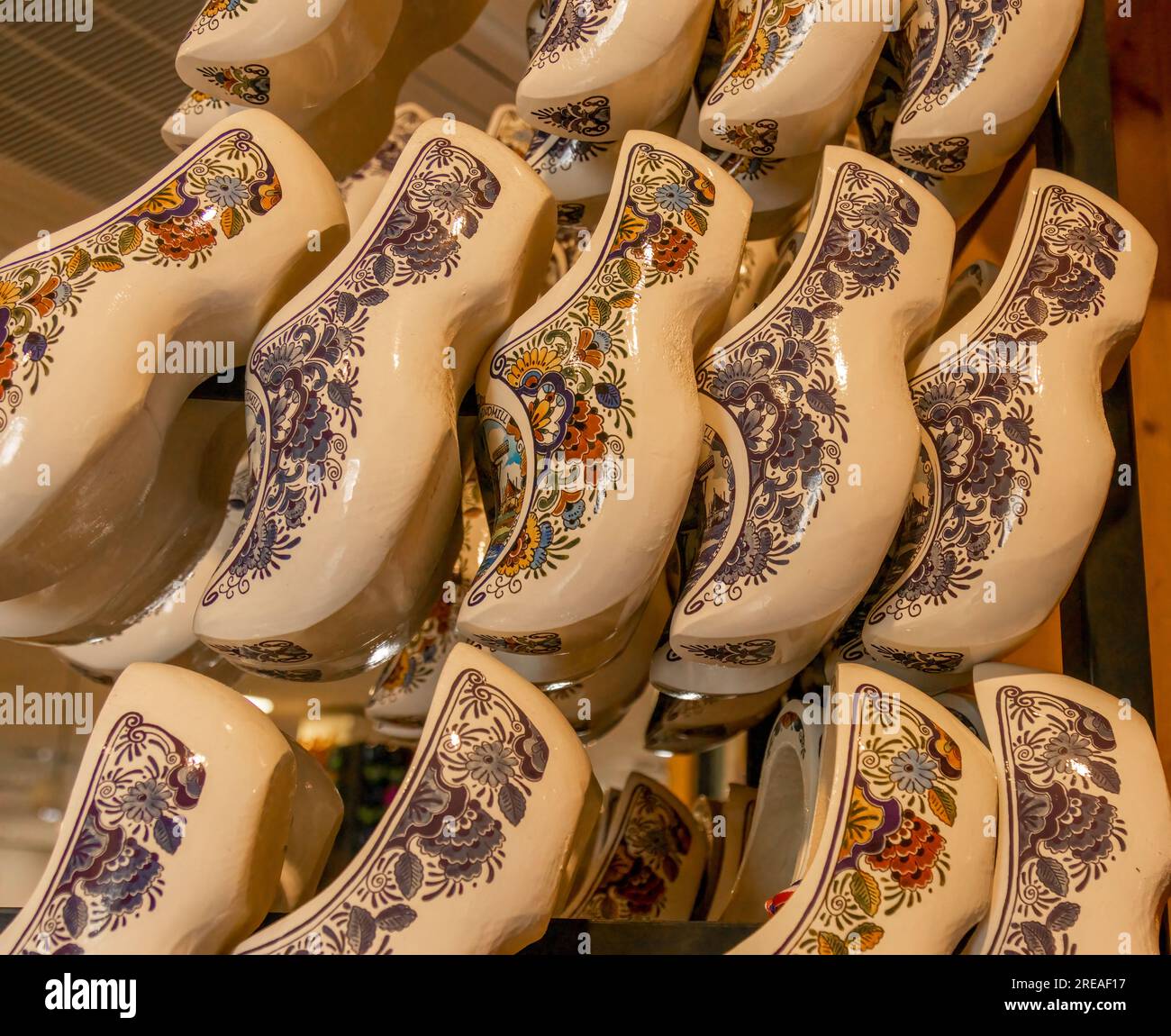 Decorated dutch wooden clogs hanging for sale in a shop in Amsterdam ...