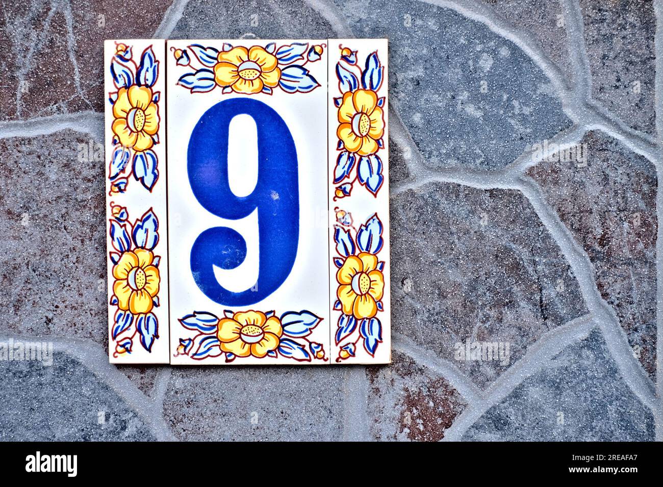 Number 9, nine, blue digit on a floral tile on a stone wall Stock Photo ...