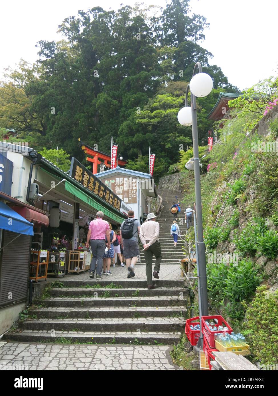 Tourists climb a flight of stone steps towards the entrance of the ...