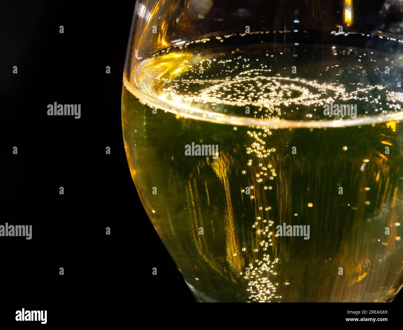 Glass of french sparkling champagne wine with bubbles on dark ...