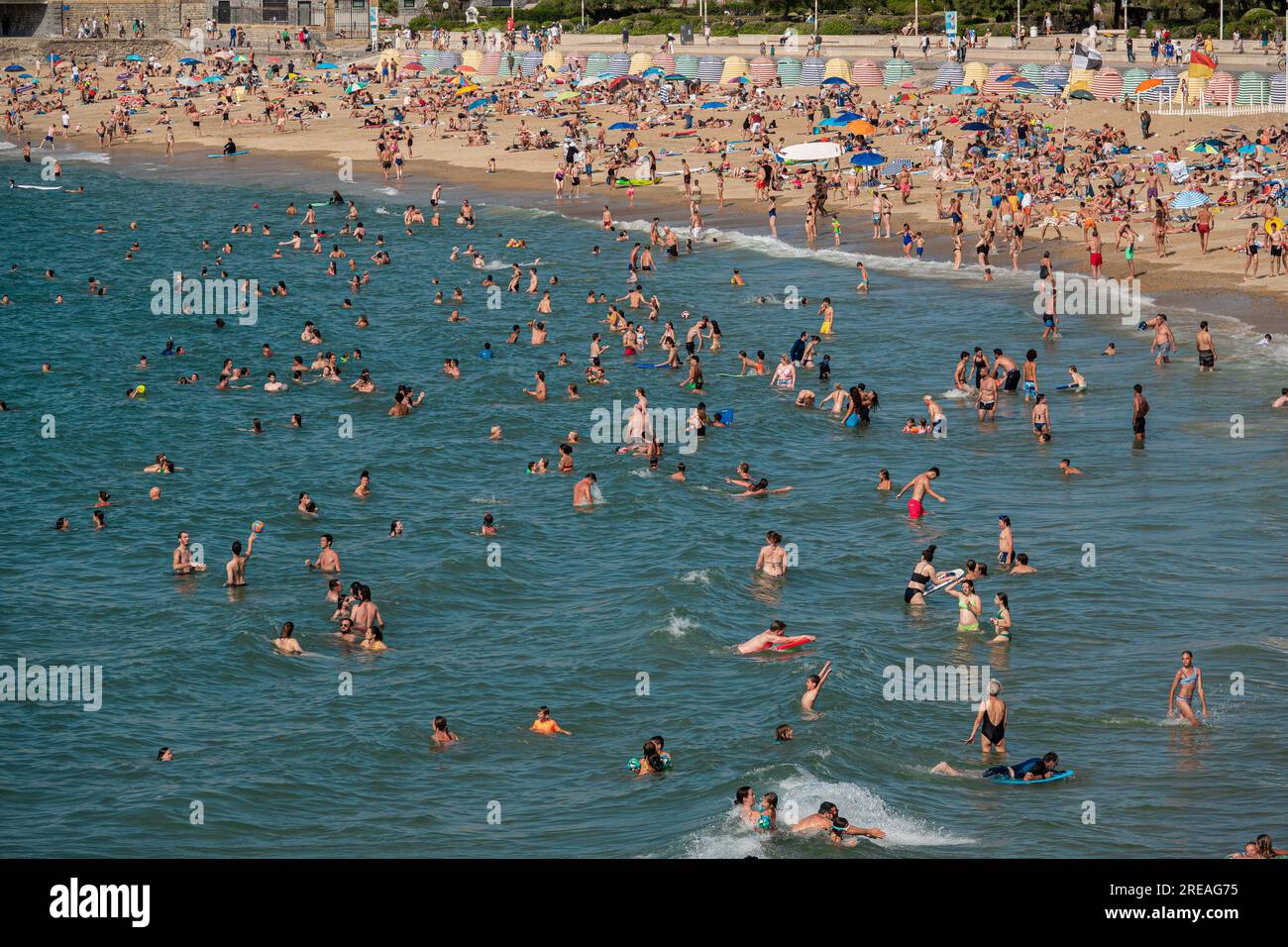 Many people bathing on a beach Stock Photo - Alamy