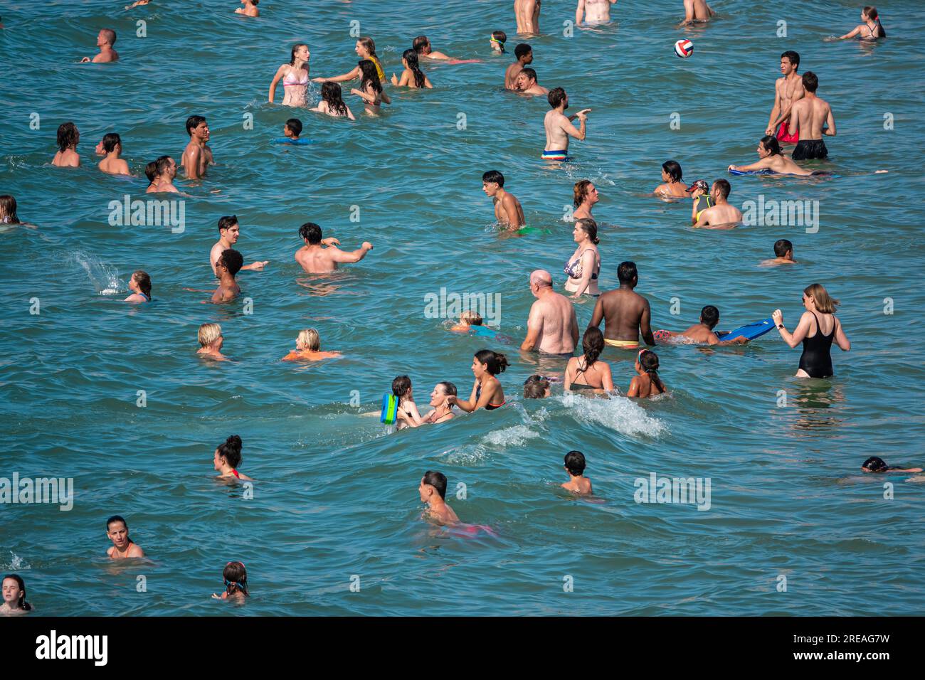 Many people bathing on a beach Stock Photo - Alamy