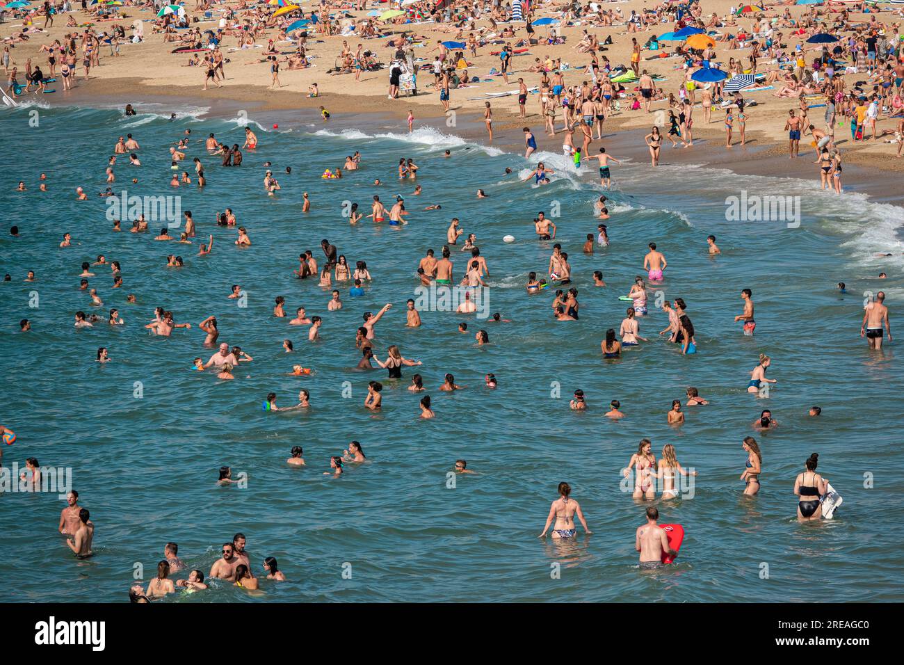 Many people bathing on a beach Stock Photo - Alamy