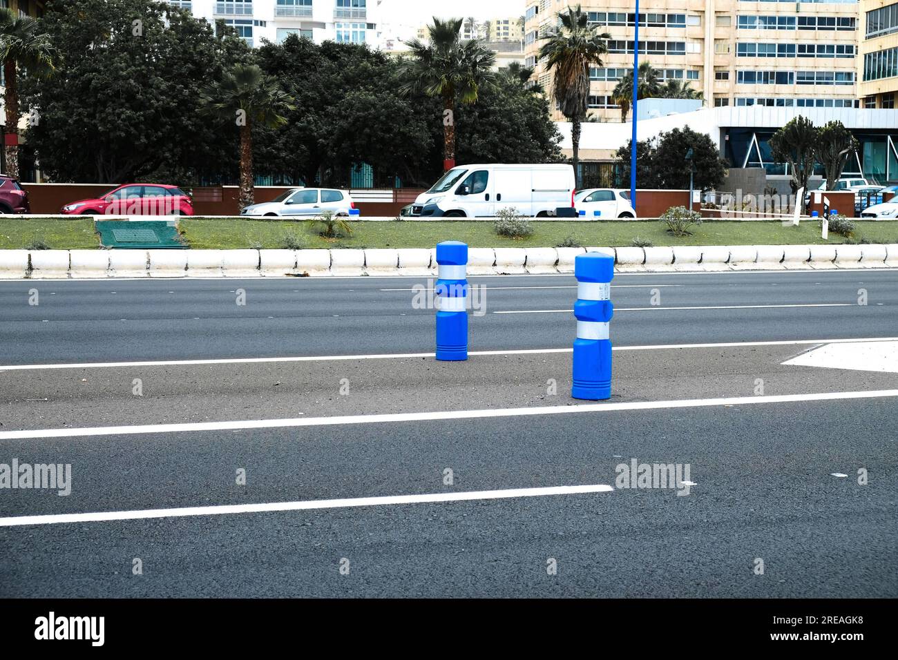 Two blue plastic traffic cones with reflective bands, road signage ...