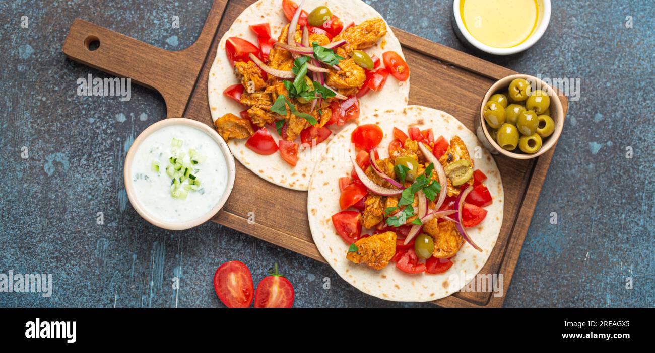 Cooking Traditional Greek Dish Gyros: Pita bread with vegetables, meat ...