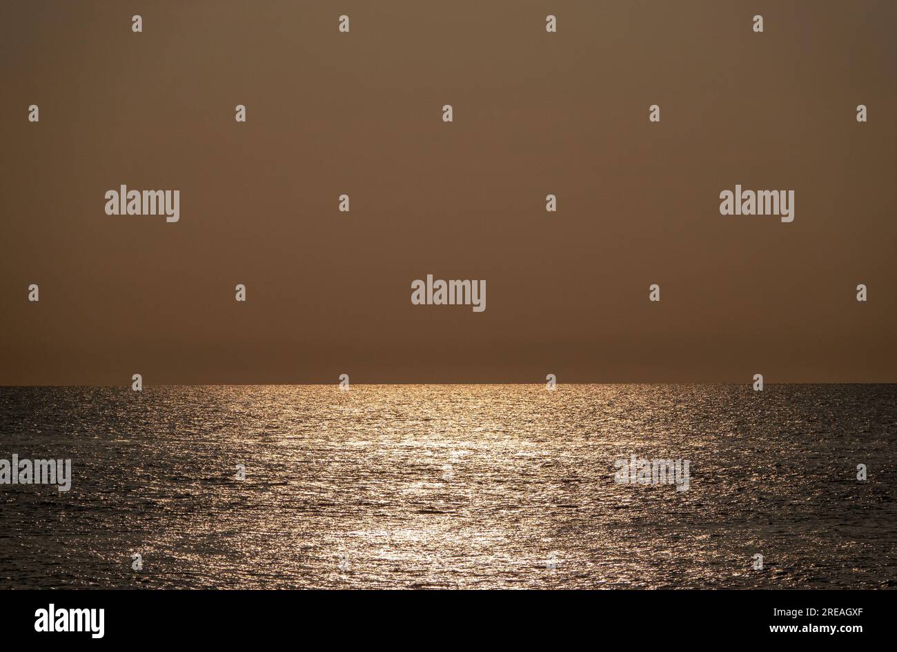 Image of a sunset with the infinite sea Stock Photo - Alamy