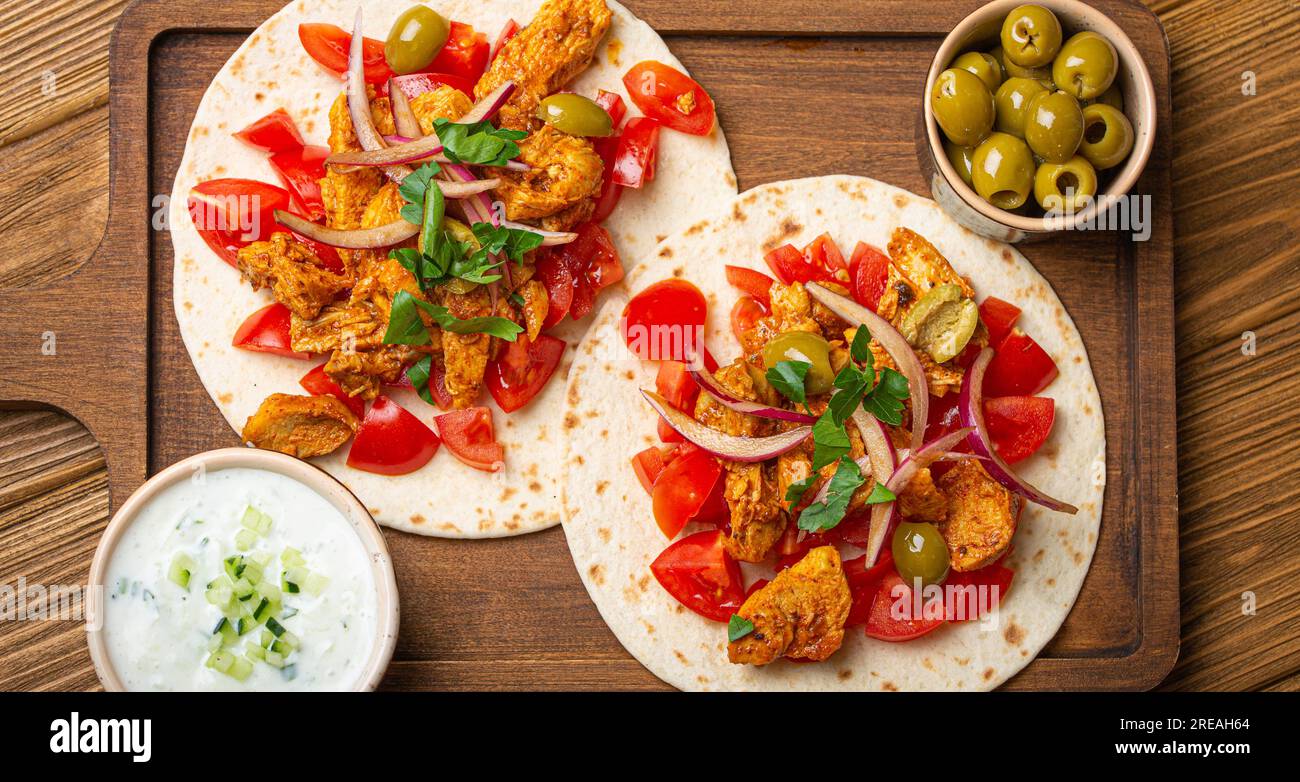 Cooking Traditional Greek Dish Gyros: Pita bread with vegetables, meat ...