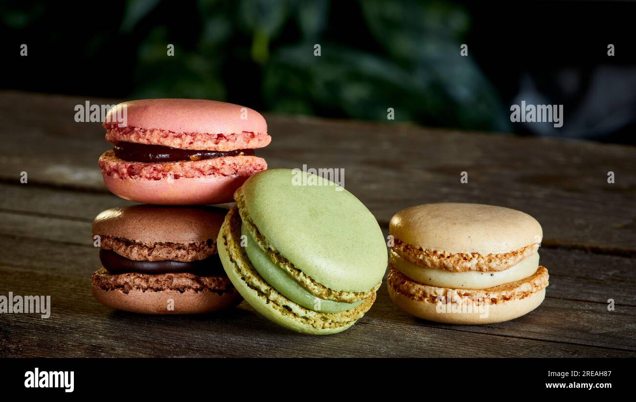 Stack of flavoured coloured macarons on a rough wooden surface Stock ...