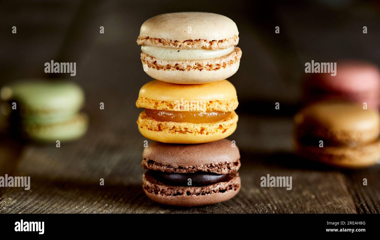 Stack of flavoured coloured macarons on a rough wooden surface Stock ...