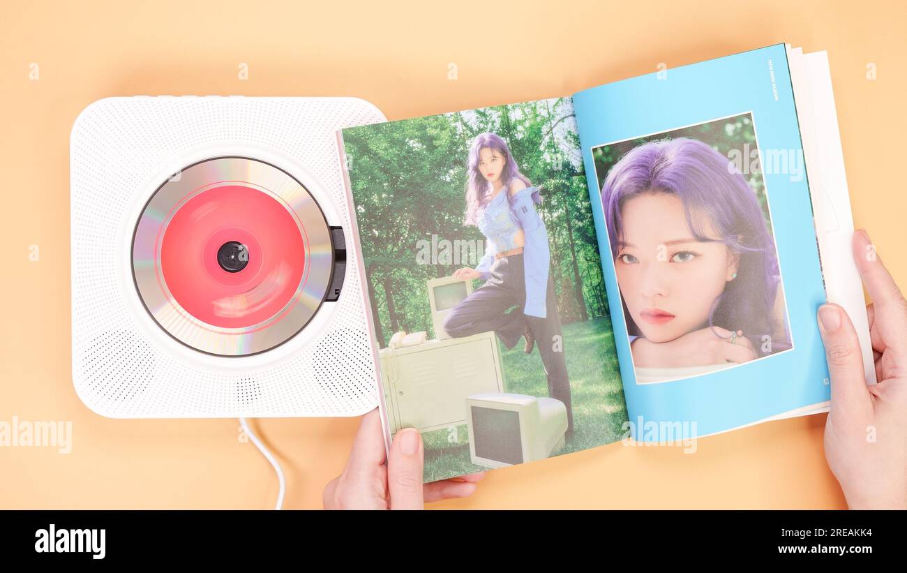 Hands holding Twice Between 1 and 2 mini Album photobook on yellow ...