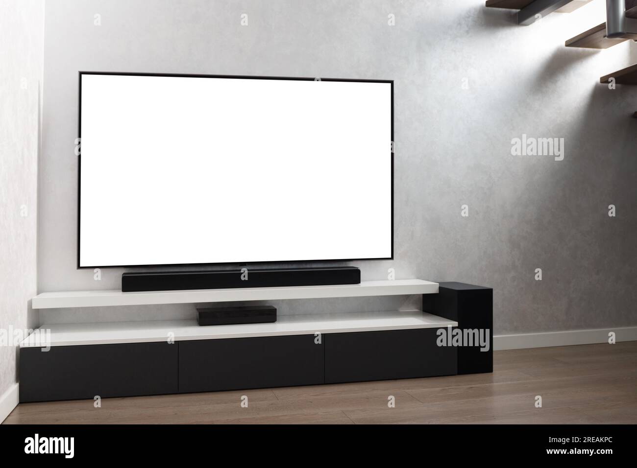 Part of the interior of the living room with a white screen TV on the ...