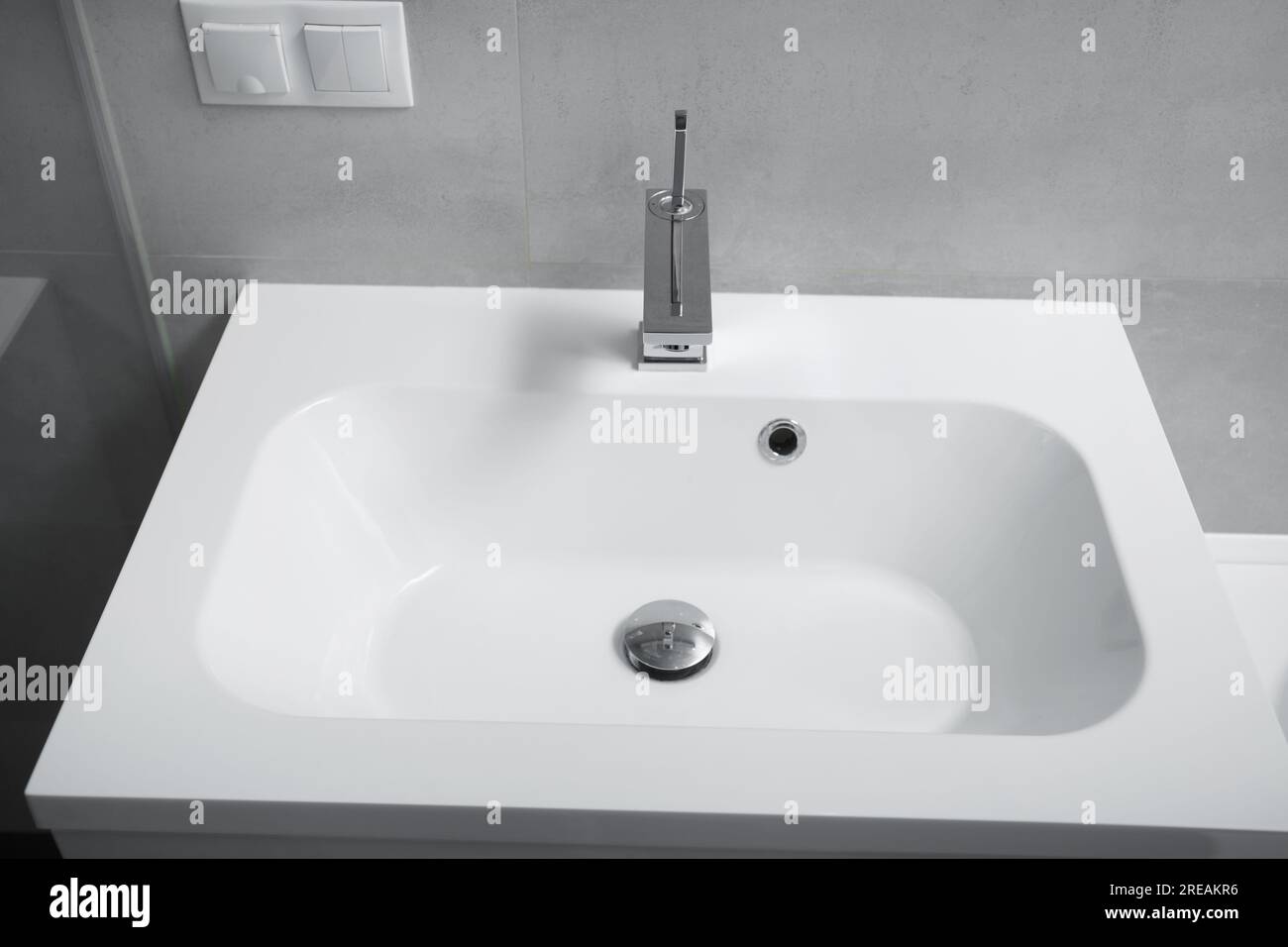 Modern bathroom interior, white washbasin with drawers, chrome faucet ...