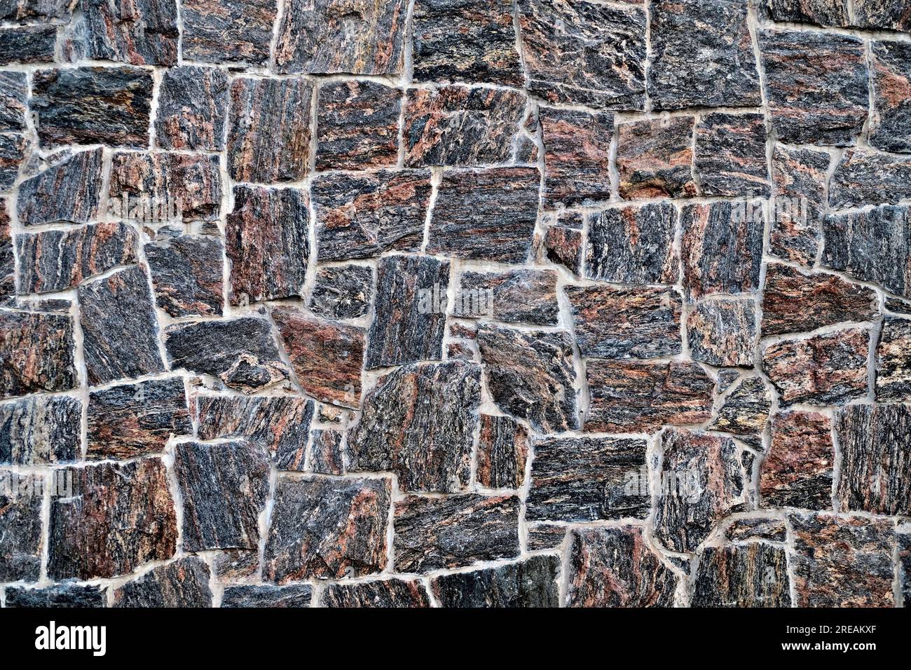 Wall pattern of irregular stones, empty space for text Stock Photo - Alamy