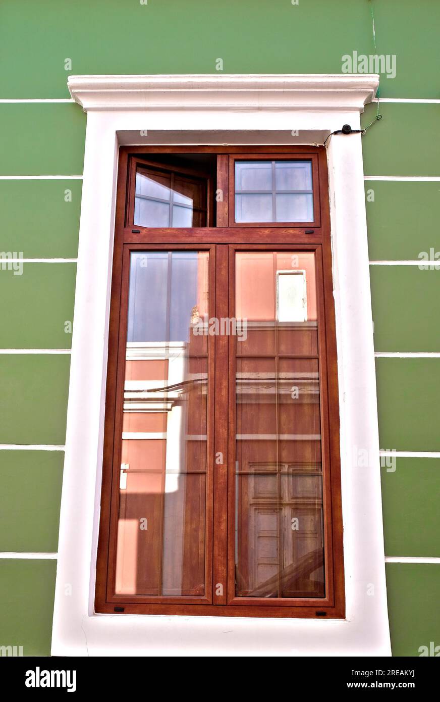 Tall wooden window frame in a green wall Stock Photo - Alamy