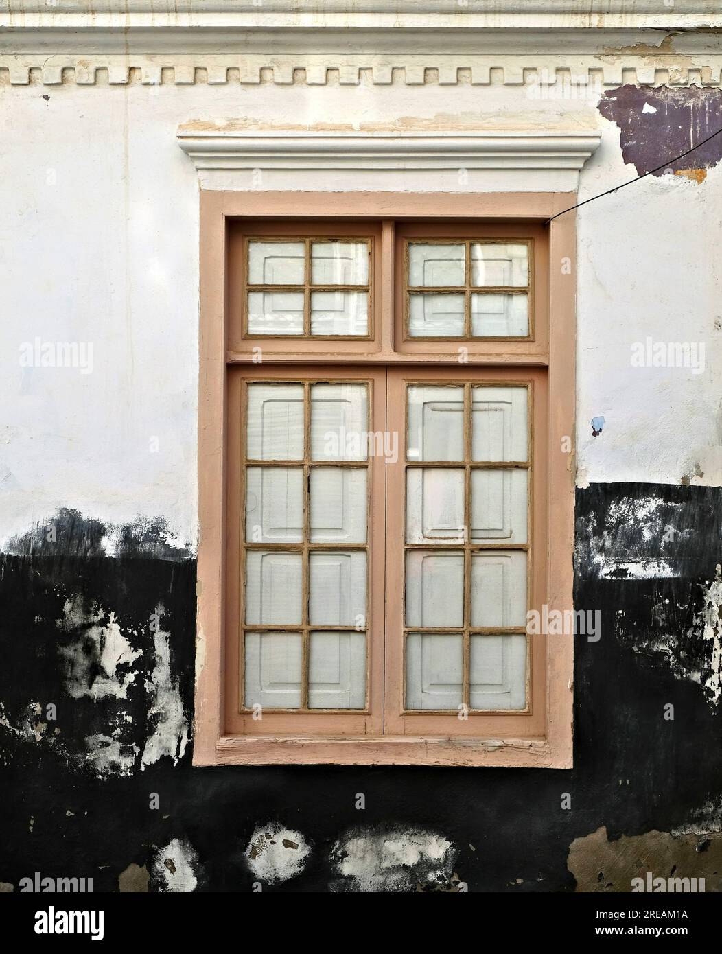 Simple old style wooden frame window, closed. Detail of an old villa ...