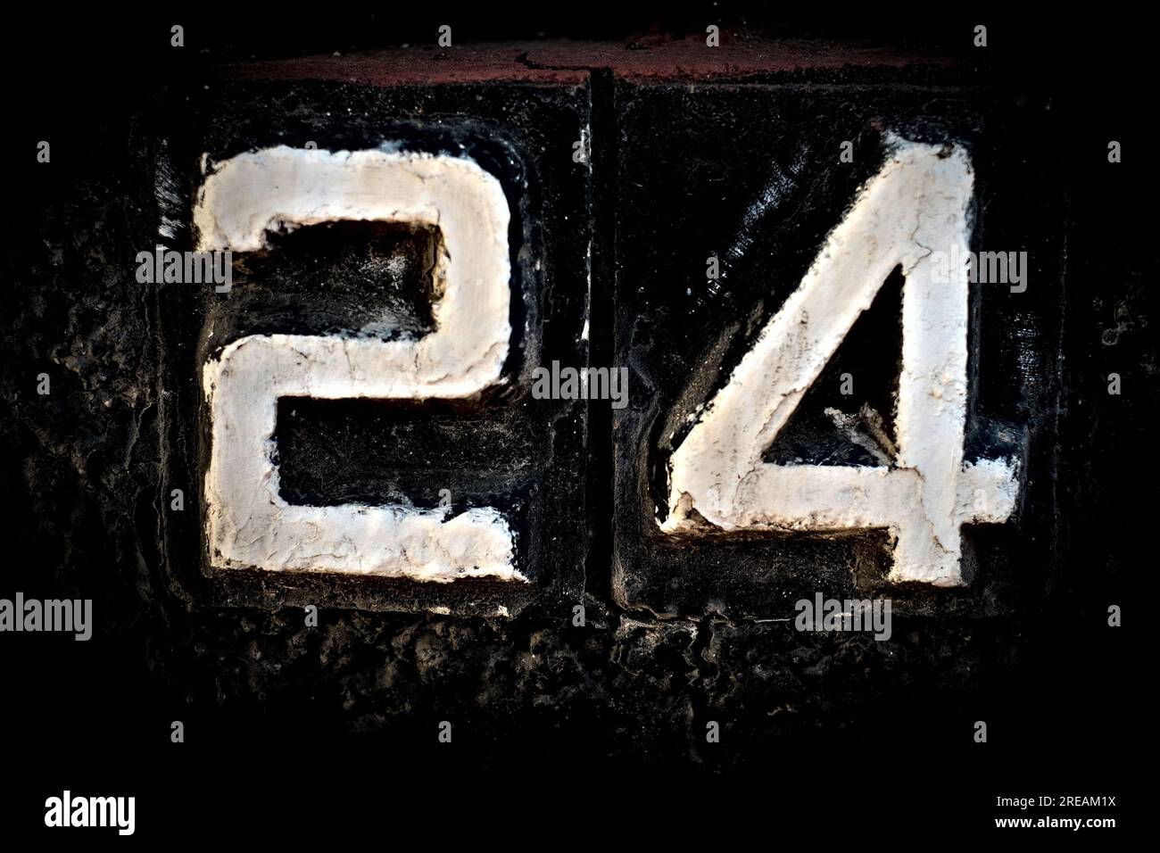 Number 24, twenty-four, large white digits on dark vignetted background ...