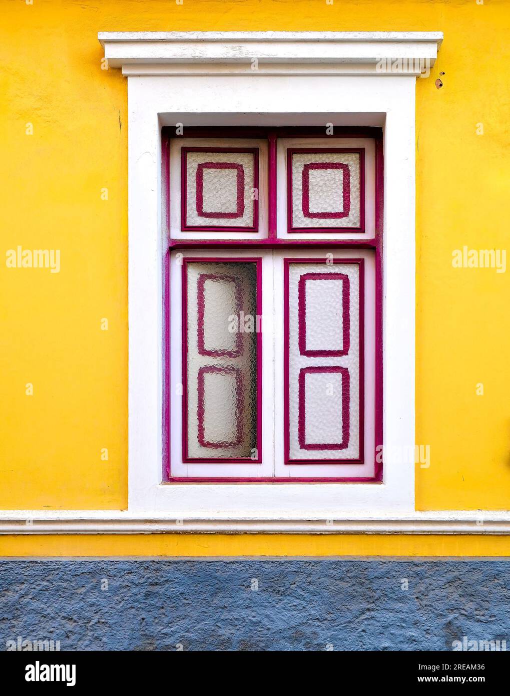 Half closed window in a yellow wall, detail of a classic villa design ...