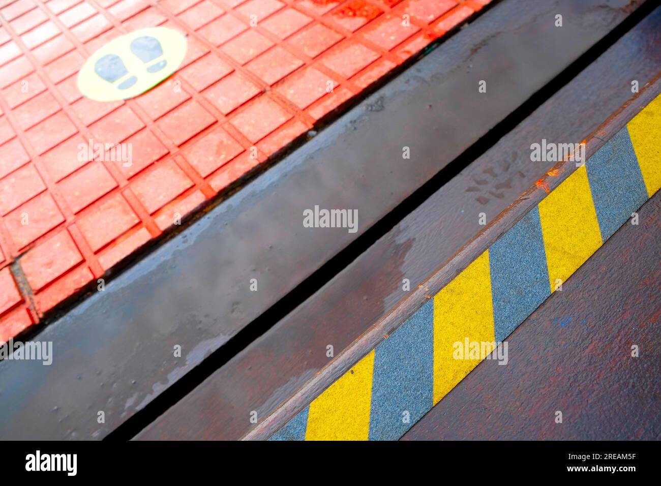 Yellow and black safety warning tape in a slippery area Stock Photo - Alamy