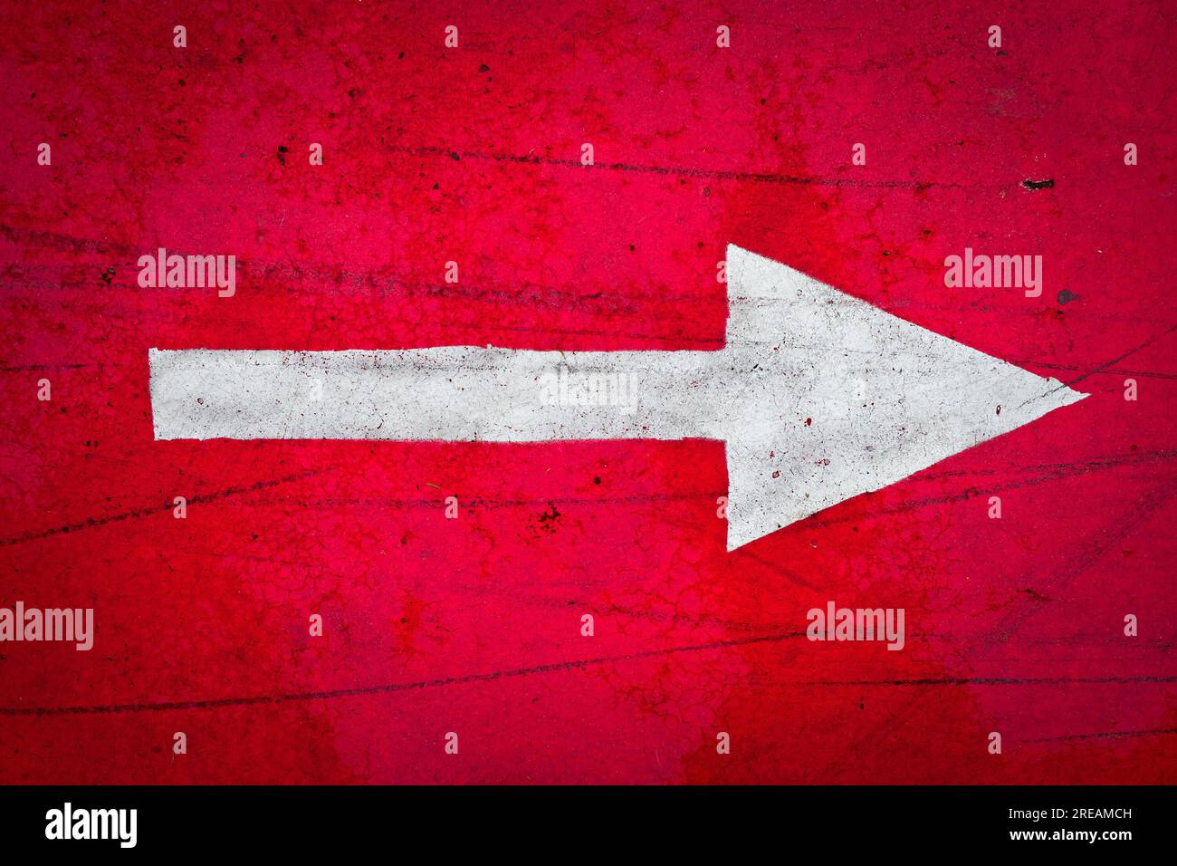 Big bold white arrow on a bright red background, vignetted Stock Photo ...