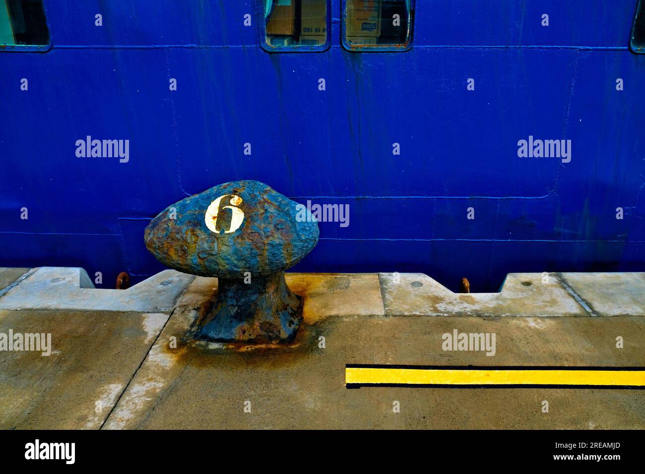Blue ship topside and a harbour bollard - details of industrial harbor ...