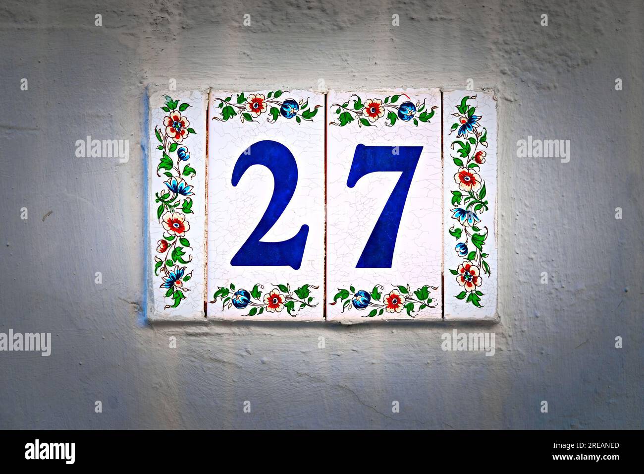 27, number twenty-seven, blue digits on floral tiles, vignetted Stock ...