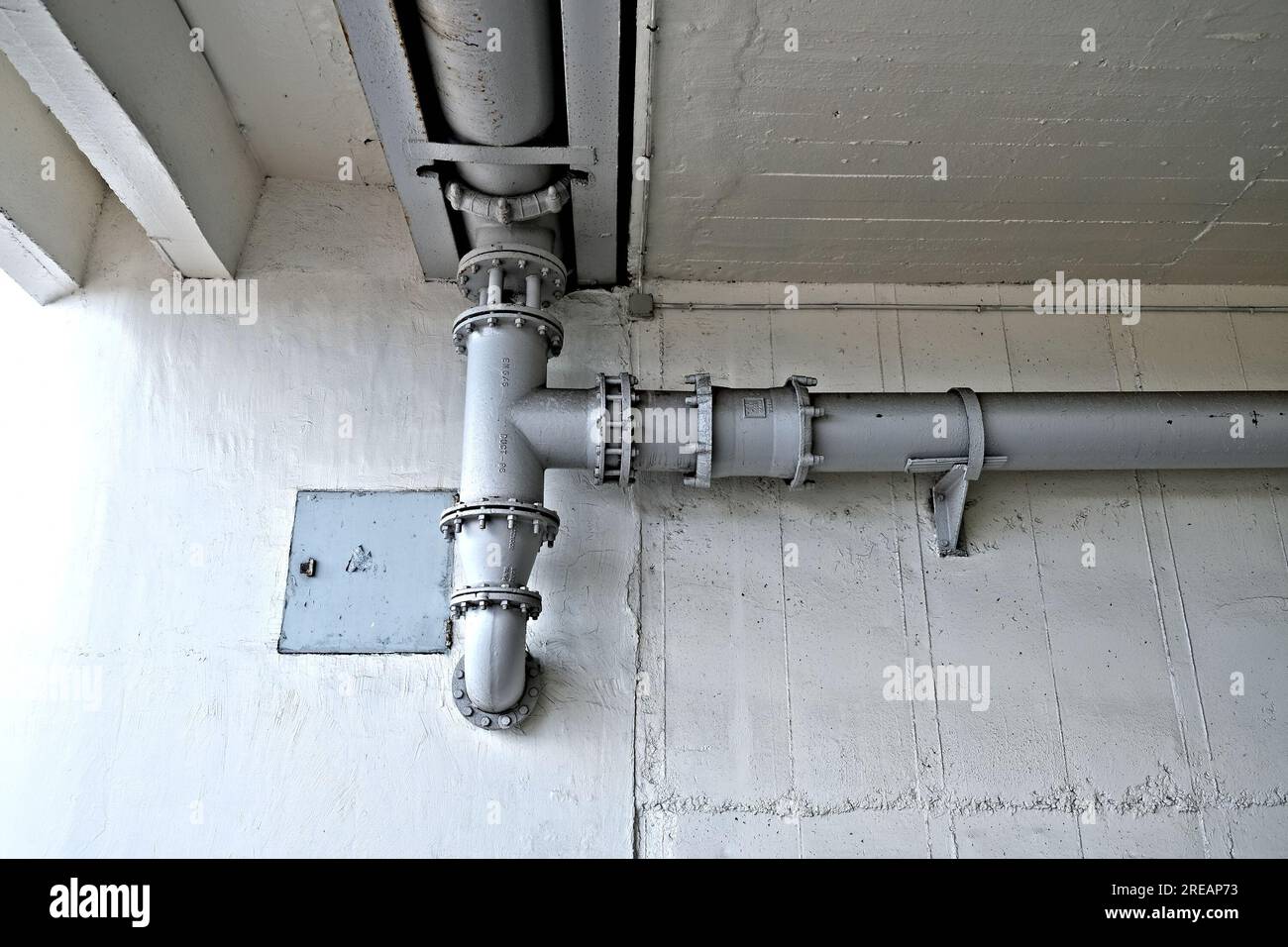 Large diameter gray plumbing tubes in a typical industrial installation ...