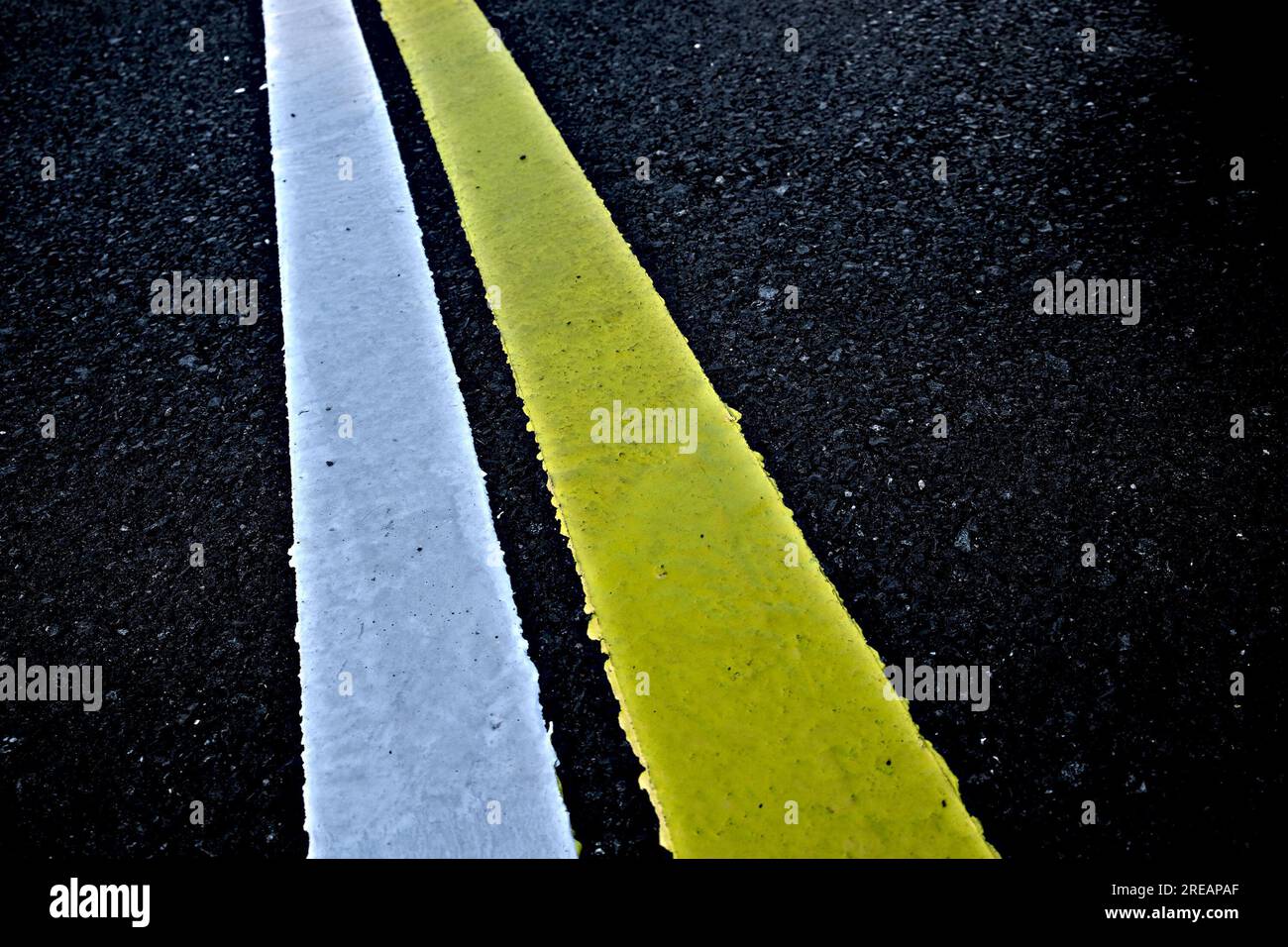 Yellow and white road marking lines on black asphalt Stock Photo - Alamy