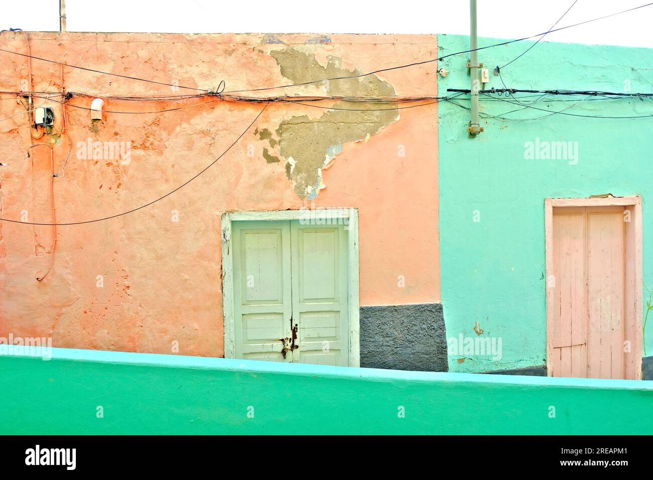 Pastel colors of pueblo homes in light green and pale orange. Latino ...
