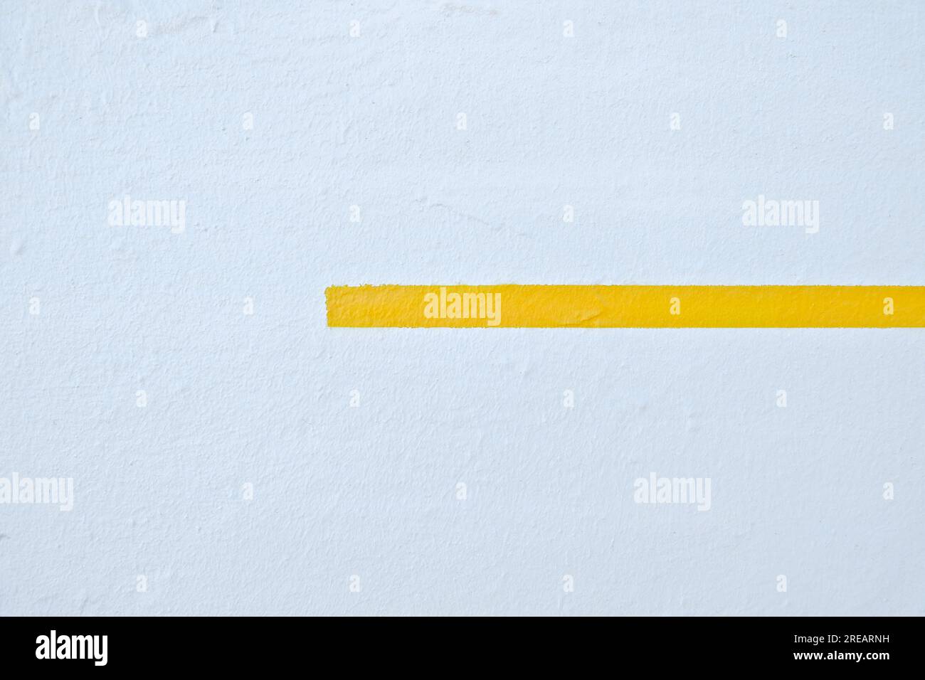A thick yellow line on a white background Stock Photo - Alamy