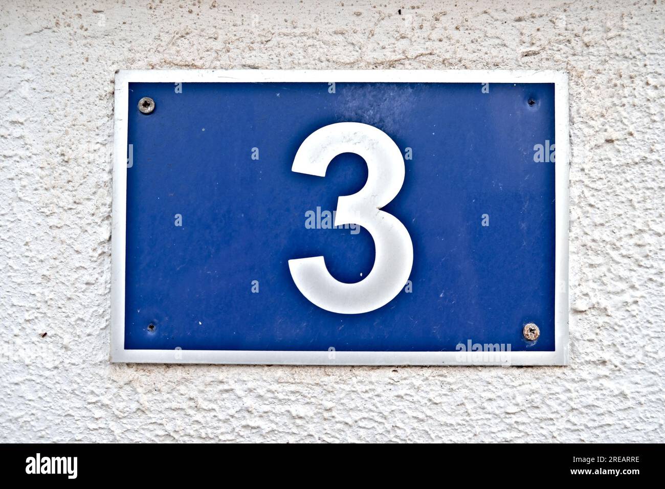 3, number three, blue plate on a white wall Stock Photo - Alamy