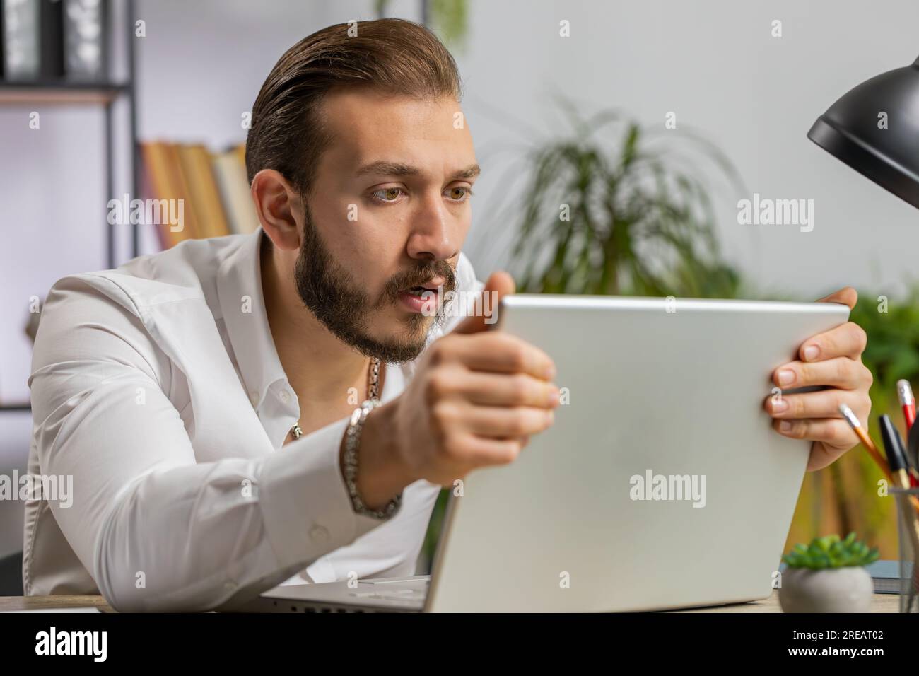Irritated tired middle eastern business man while working on laptop ...