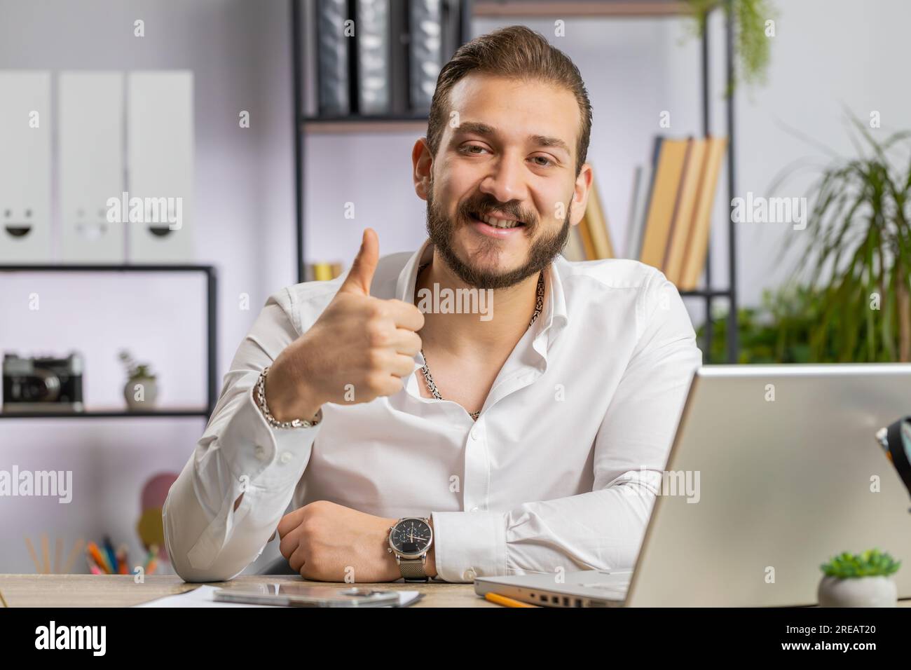 Like. Happy middle eastern businessman guy working on laptop looking ...