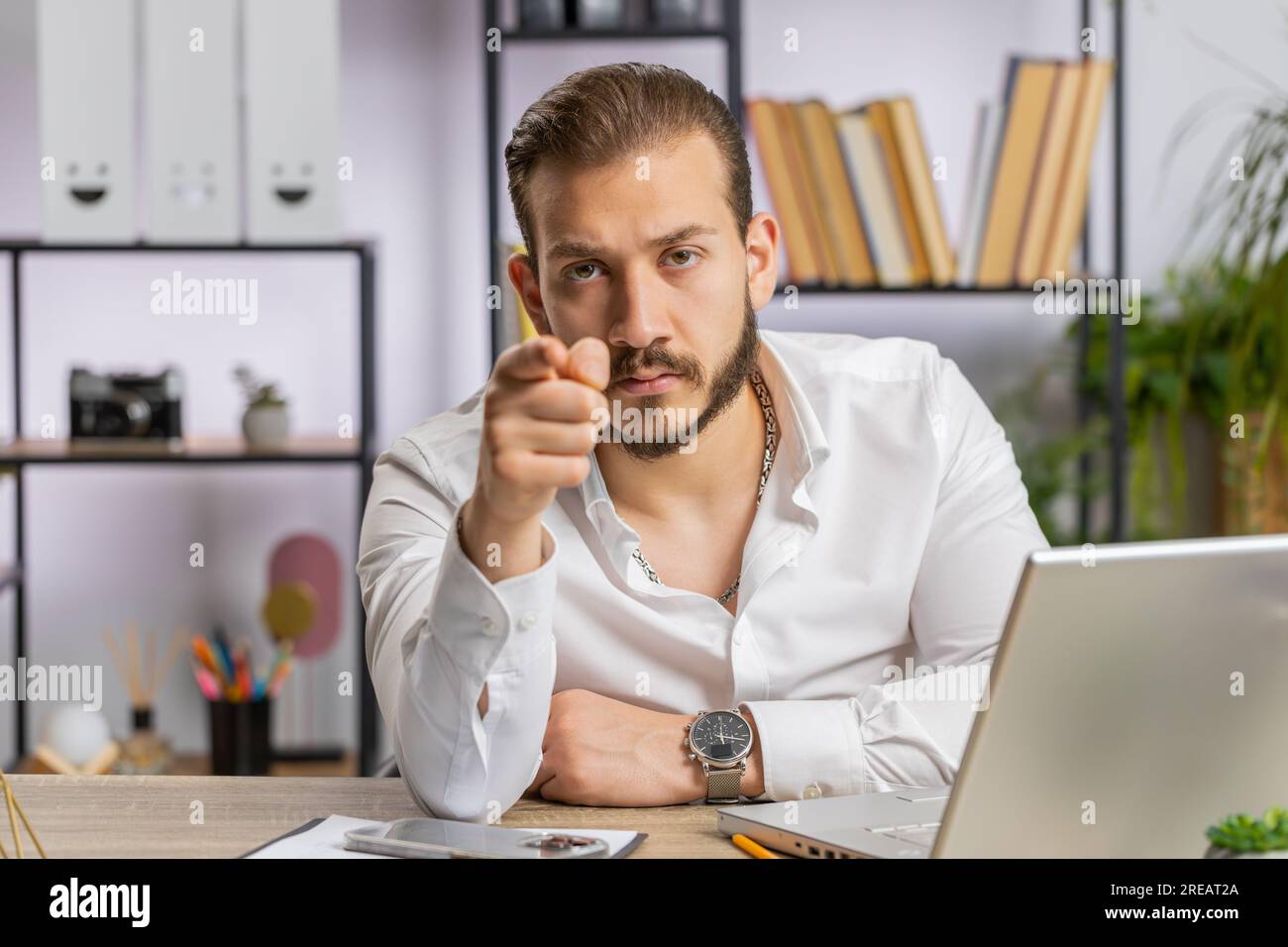 I choose you. Middle eastern businessman programmer software developer working on office laptop ...