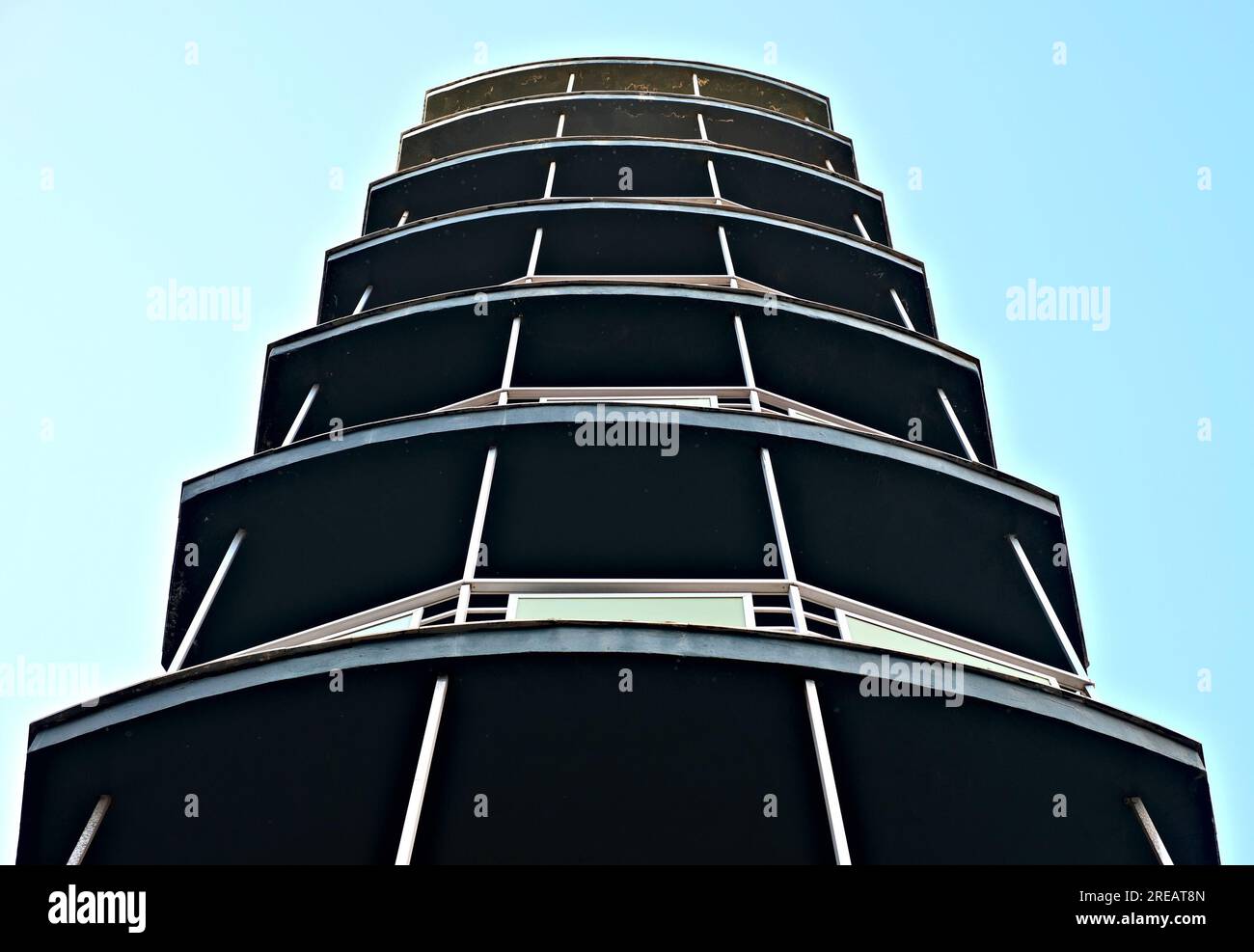 Tall multi storey building with many balconies in low angle view ...